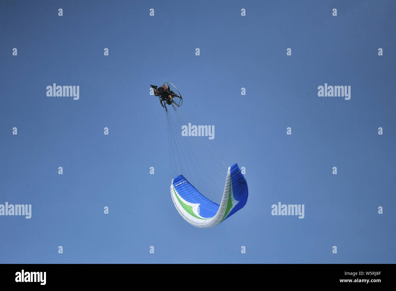 A wingsuit flyer jumps from a high place to glide through the air ...