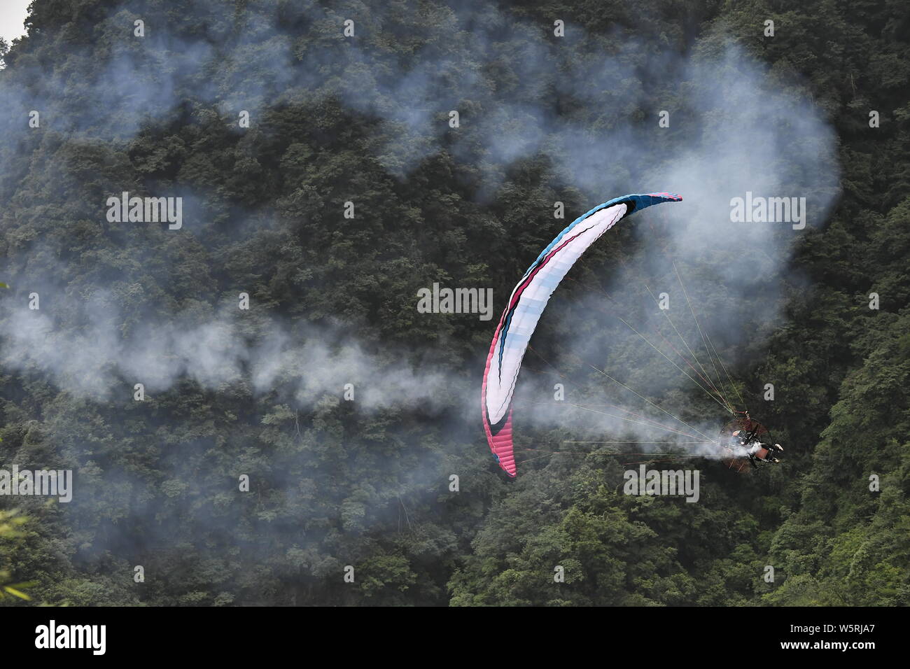 A wingsuit flyer jumps from a high place to glide through the air ...