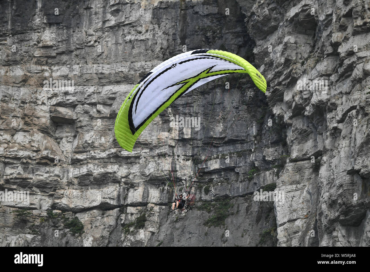 A wingsuit flyer jumps from a high place to glide through the air ...