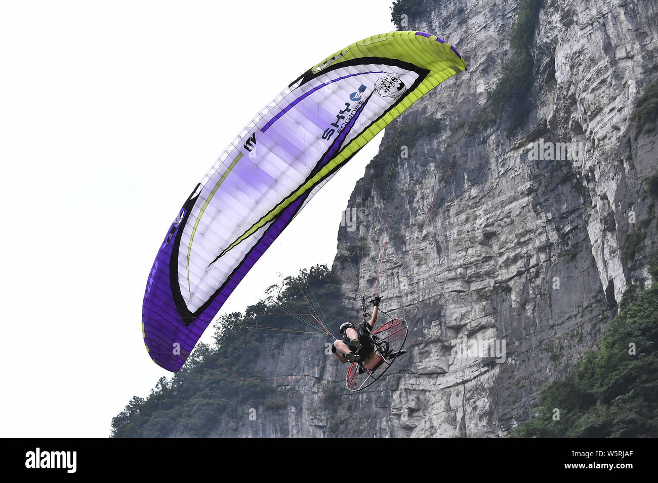 A wingsuit flyer jumps from a high place to glide through the air ...