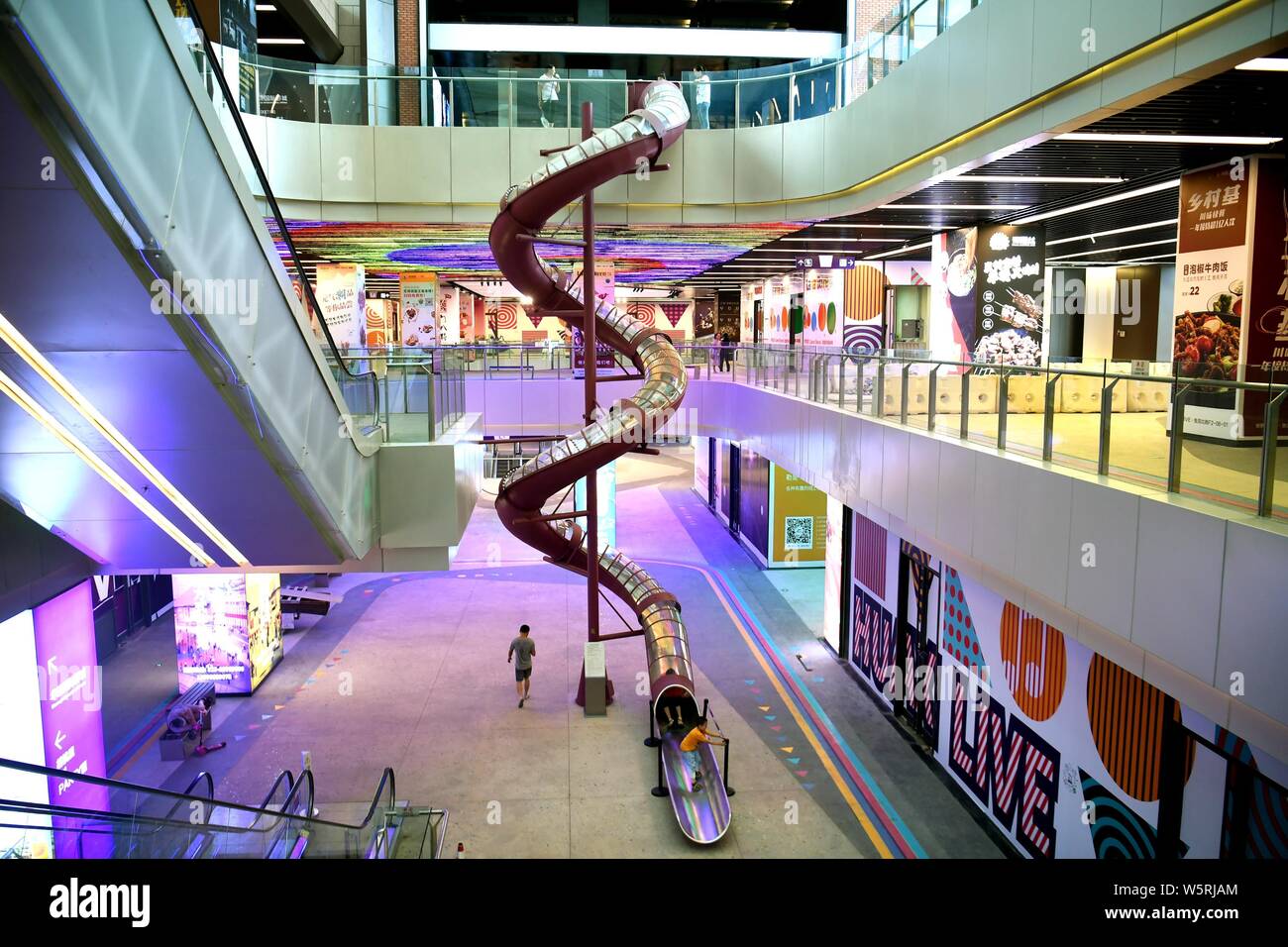 Young Chinese kids try out the three-storey-high spiral slide at a ...