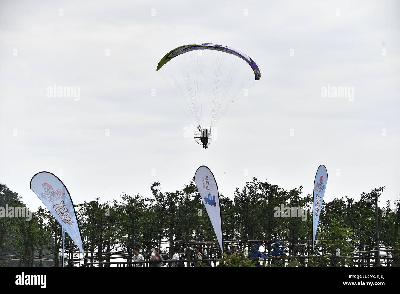 A wingsuit flyer jumps from a high place to glide through the air ...