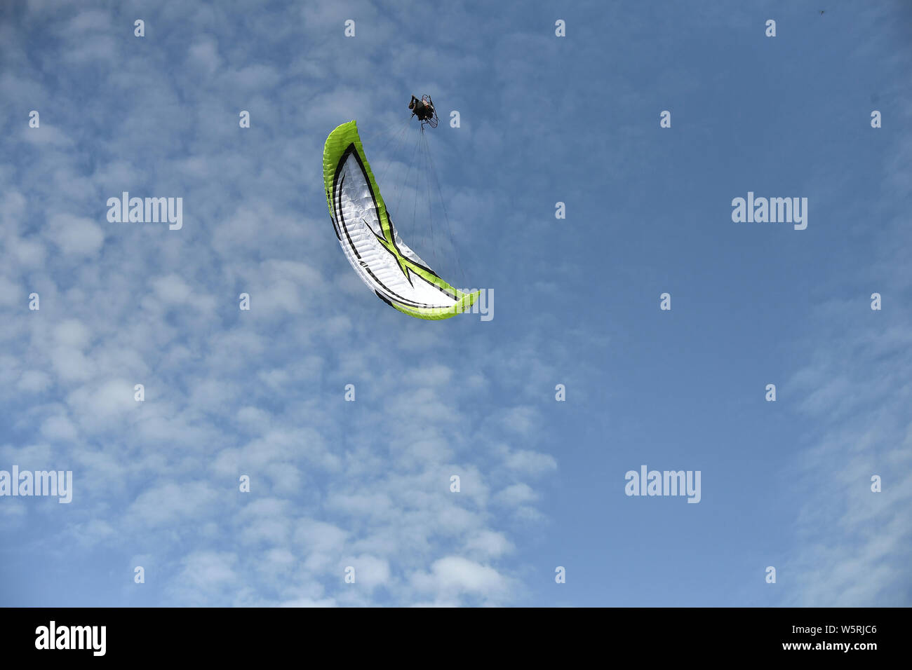 A wingsuit flyer jumps from a high place to glide through the air ...
