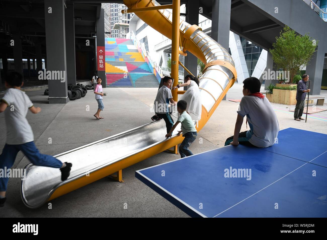 A child tries out a 10-meter-high spiral slide from the first floor of ...