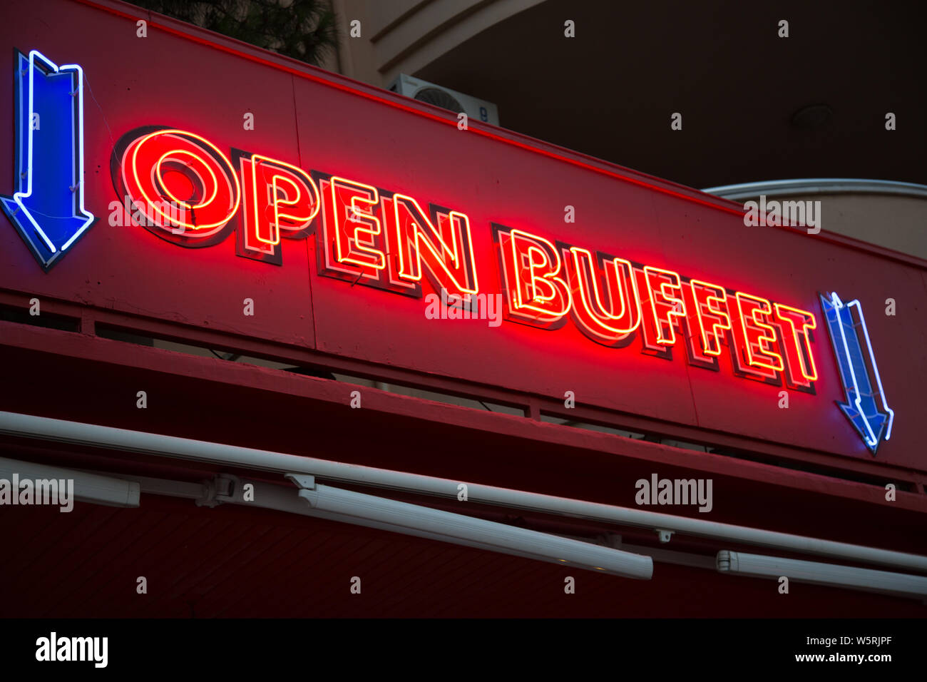 Neon sign advertising an open buffet restaurant Stock Photo - Alamy