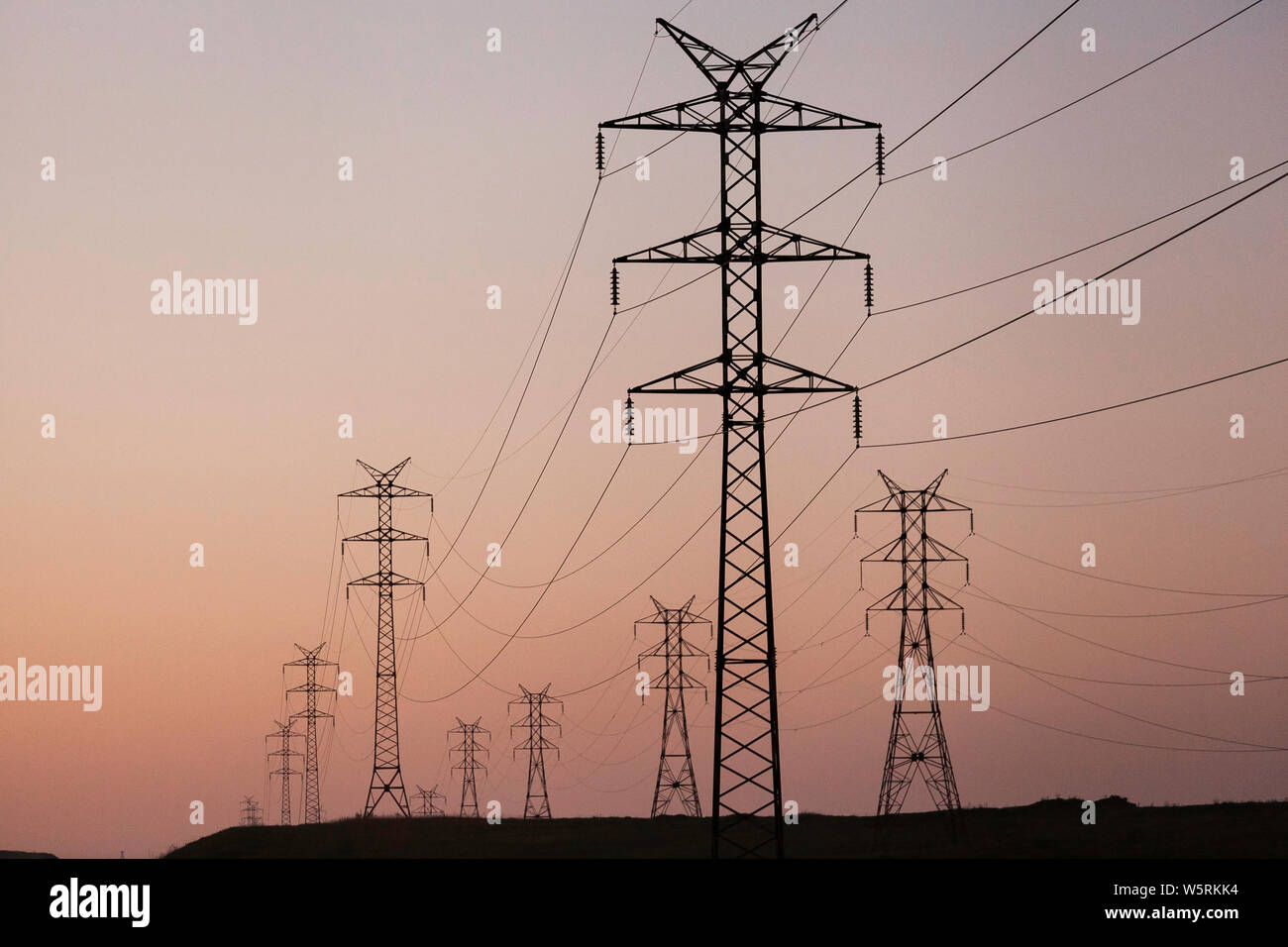 Perspective with many Power Line on sunset Stock Photo - Alamy