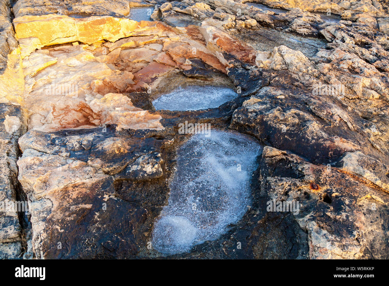 Extraction of sea salt from the evaporation of seawater in stone pools ...