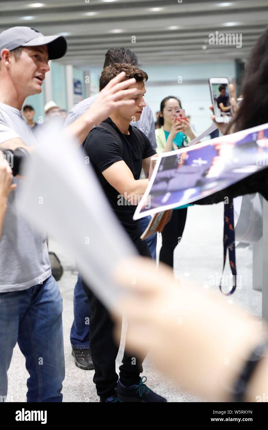 English actor and dancer Tom Holland signs autographs for fans as he ...