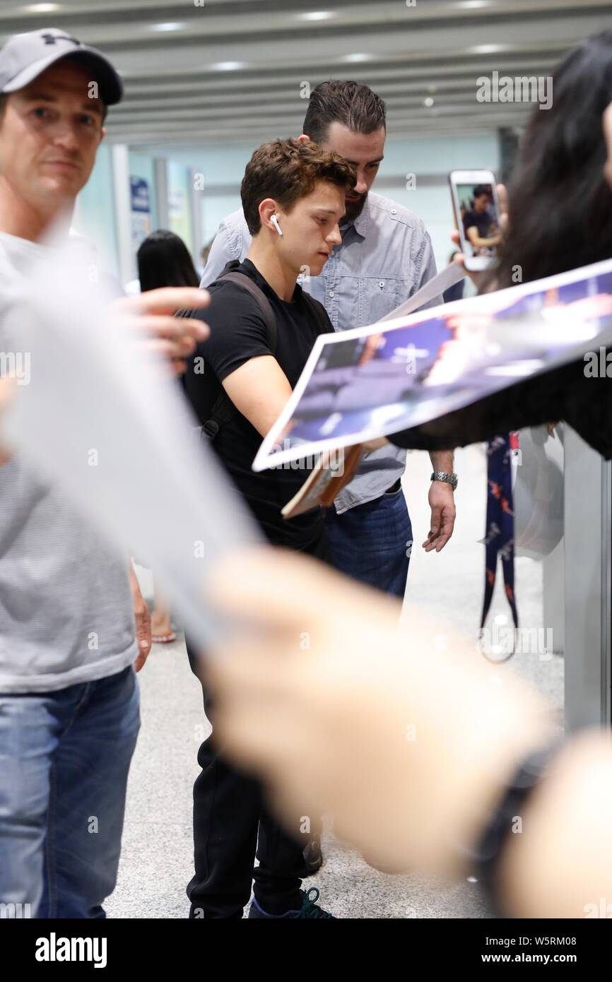 English actor and dancer Tom Holland signs autographs for fans as he ...