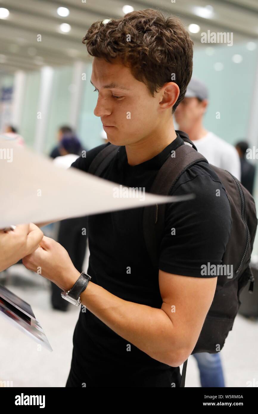 English actor and dancer Tom Holland signs autographs for fans as he ...