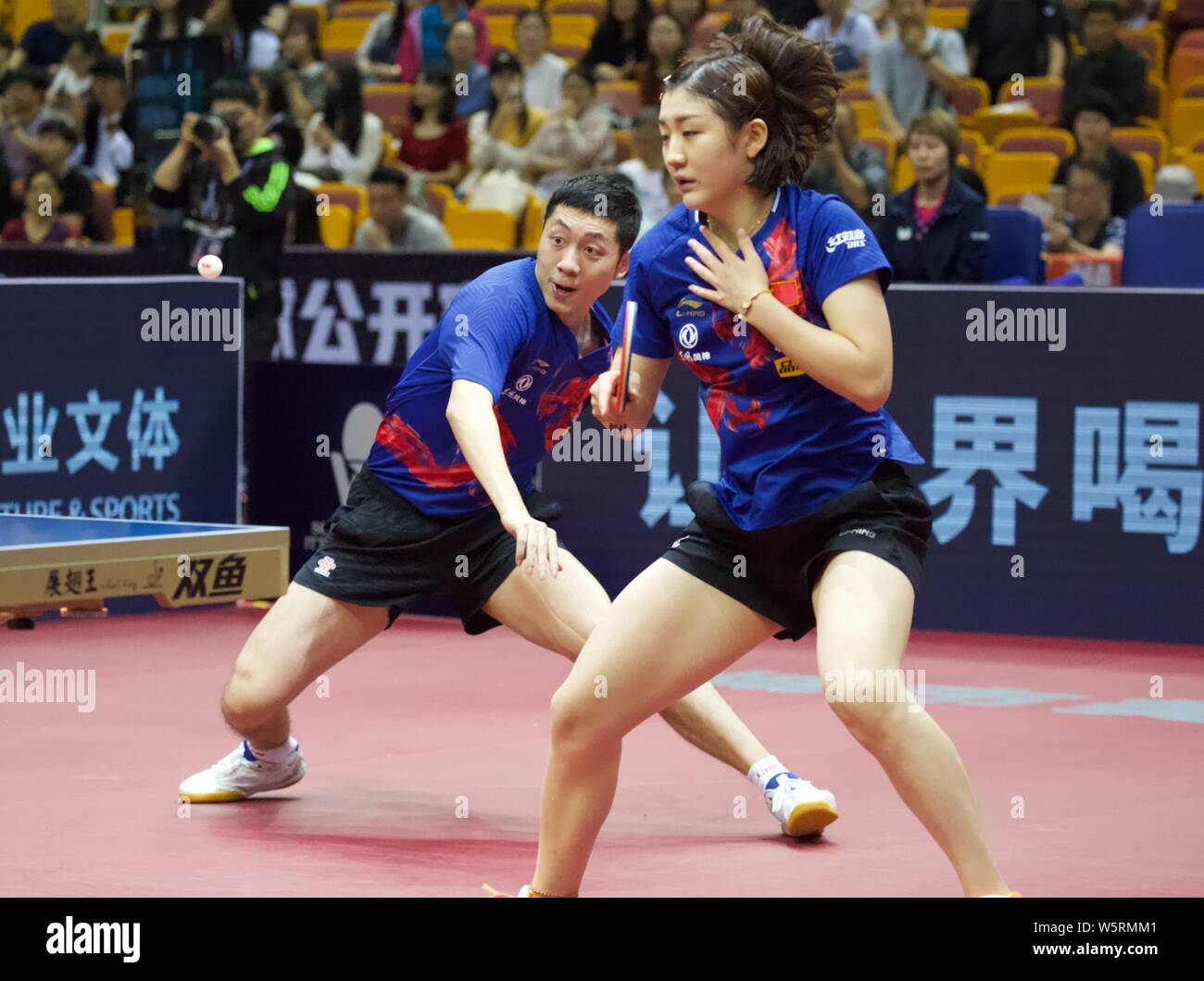 Xu Xin and Chen Meng of China return a shot to Lin Yen-jui and Cheng I-ching of Chinese Taipei ...