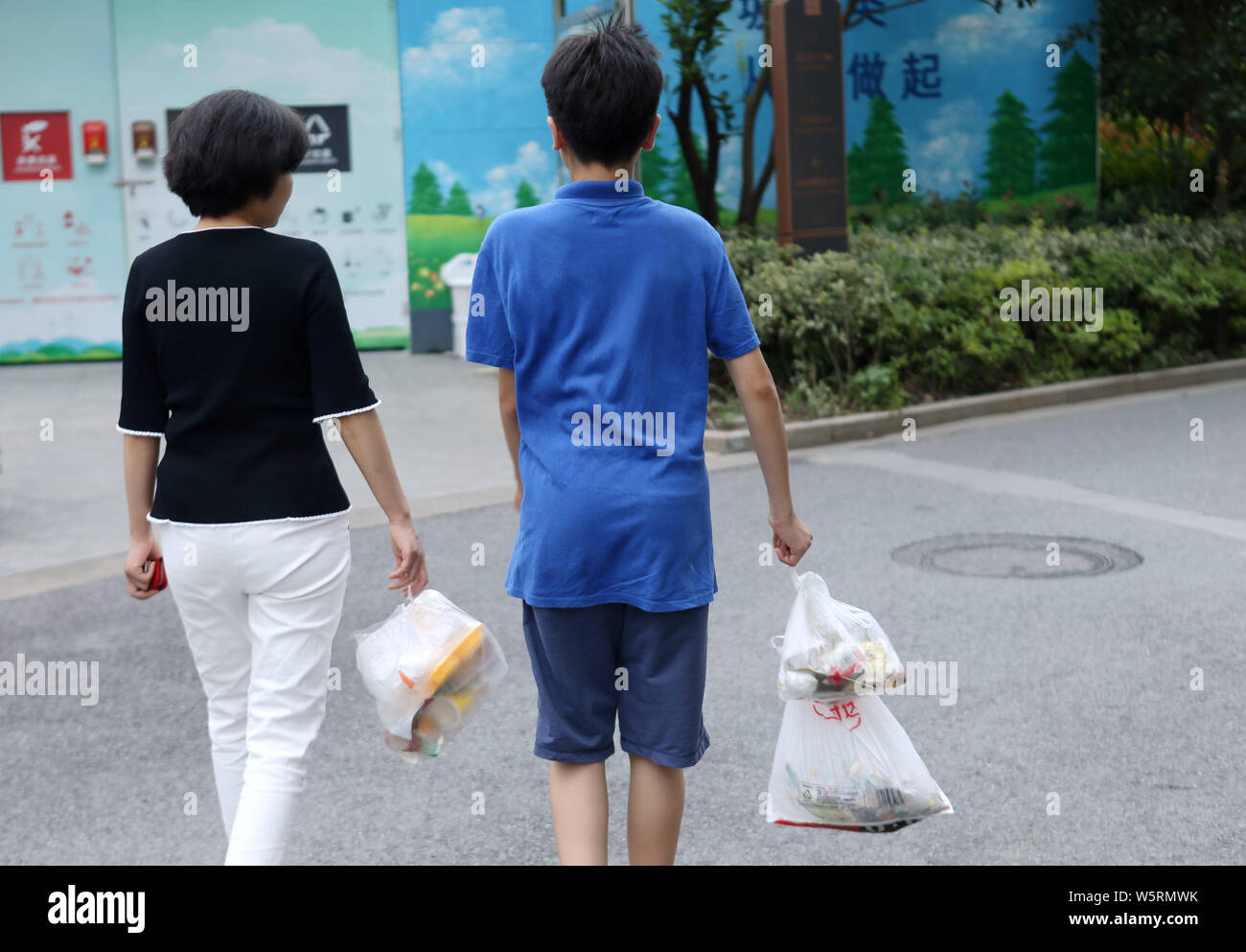 Local residents use QR code cards to open different bins to put their ...