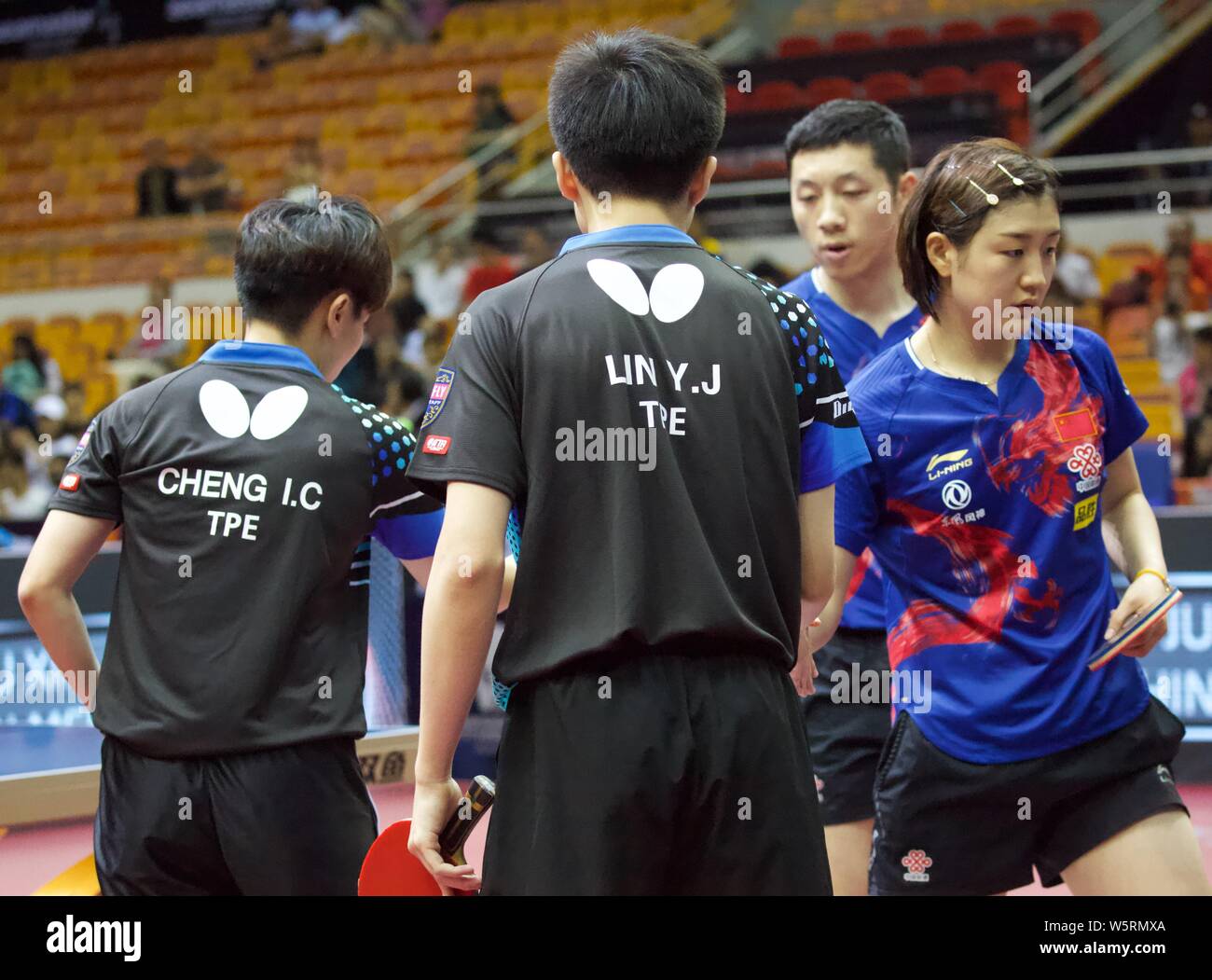Xu Xin and Chen Meng of China shake hands with Lin Yen-jui and Cheng I ...