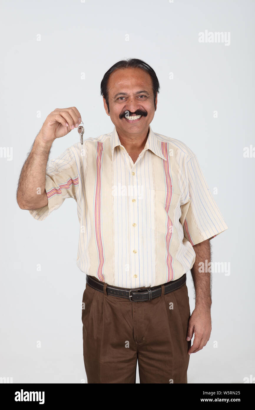 Portrait of a man holding keys Stock Photo - Alamy