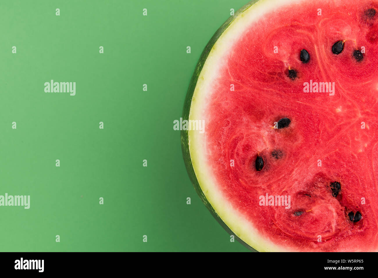 Watermelon Sliced in Half, Top View on Green Pastel Background Stock ...