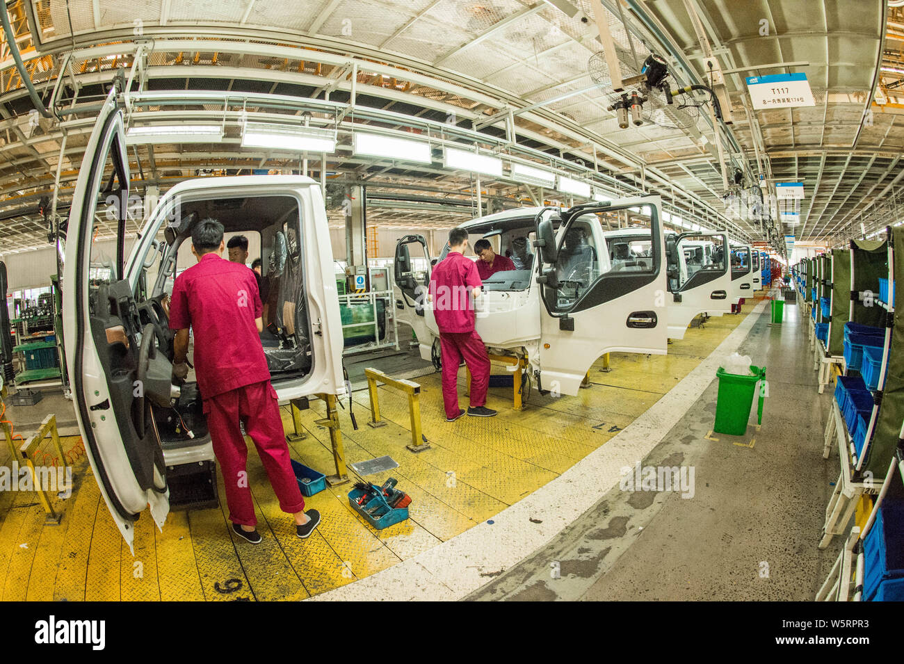 Chinese workers assemble vehicles on the assembly line at the auto ...