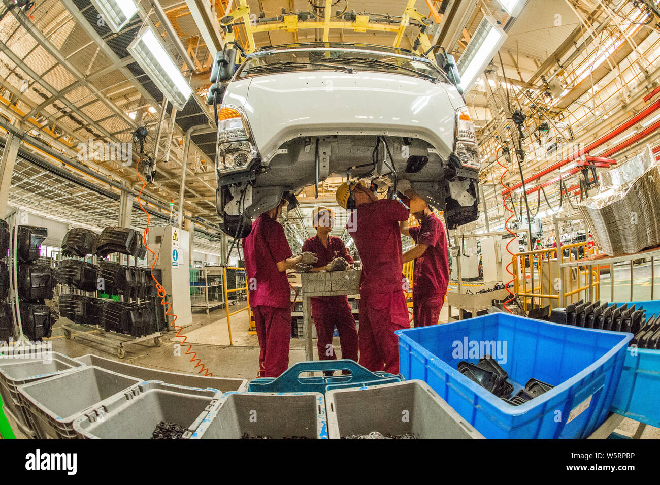 Chinese workers assemble vehicles on the assembly line at the auto ...