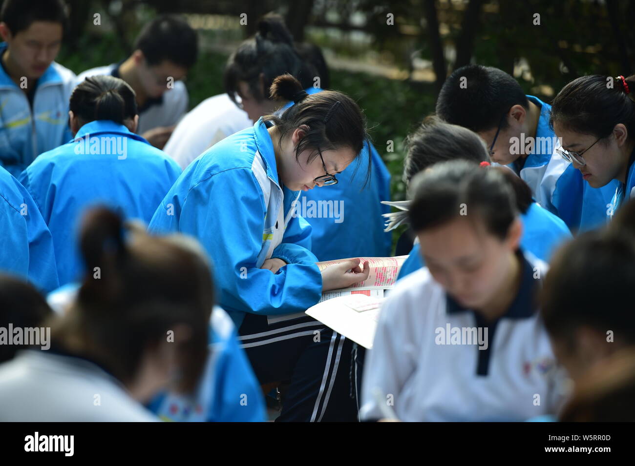 Young Chinese student examinees make final reviews of textbooks before ...