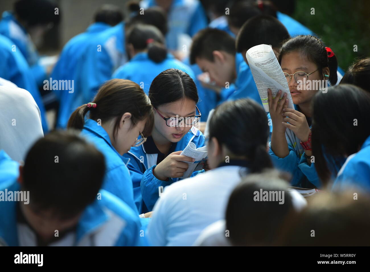 Young Chinese student examinees make final reviews of textbooks before ...