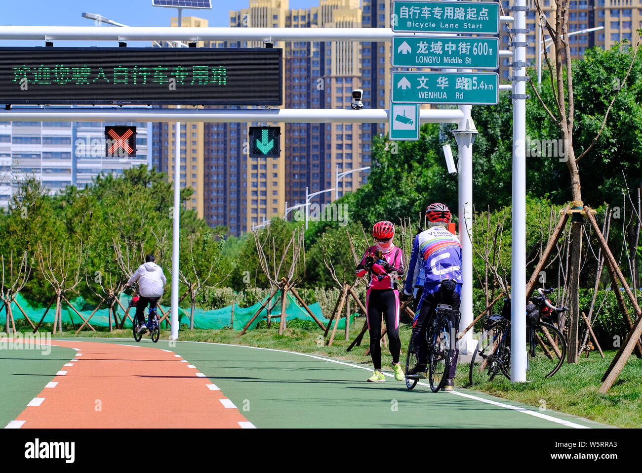 Local residents ride bikes on the first bicycle-only road, which is ...