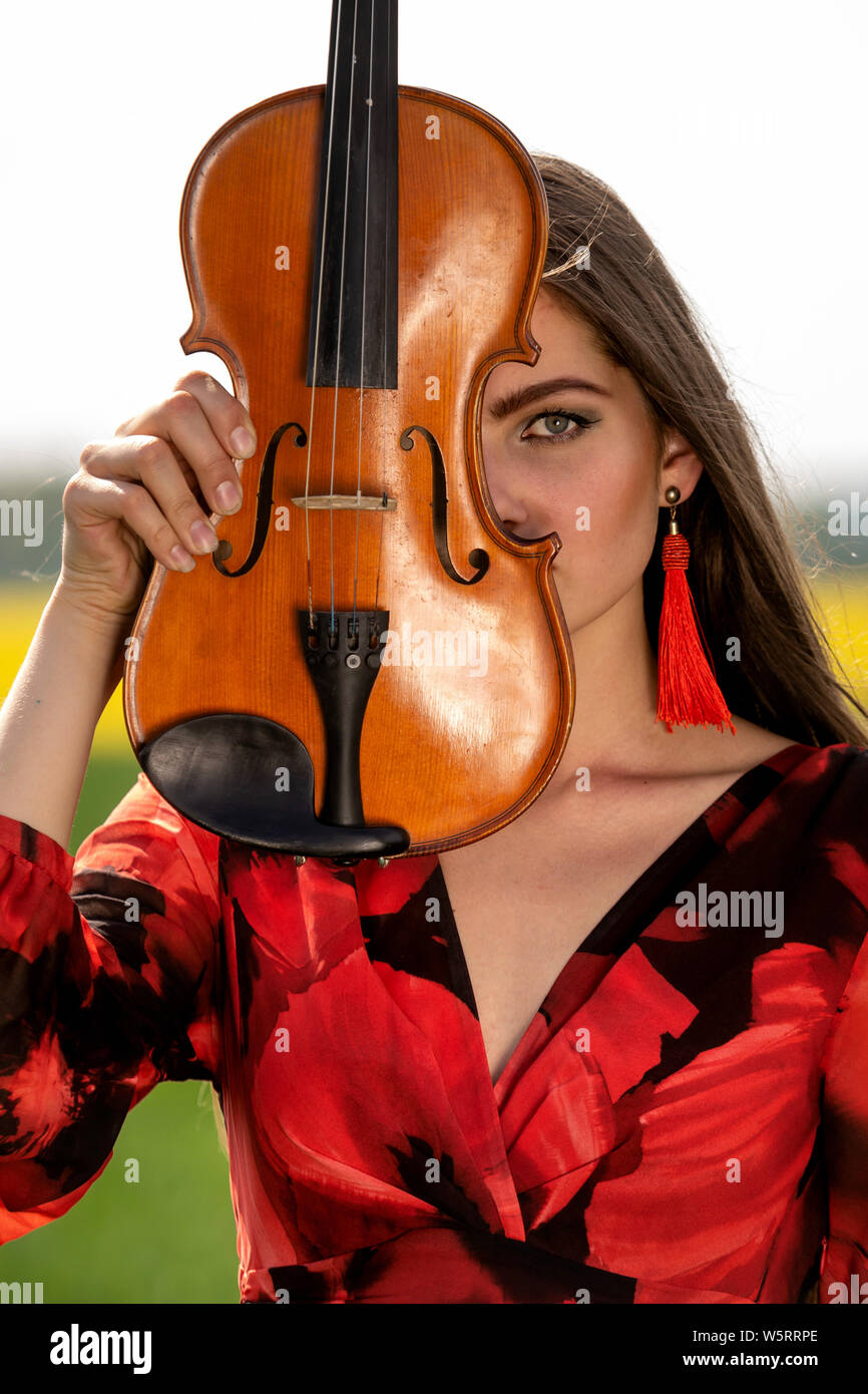 Portrait of a positive young woman. Part of the face is covered by the ...
