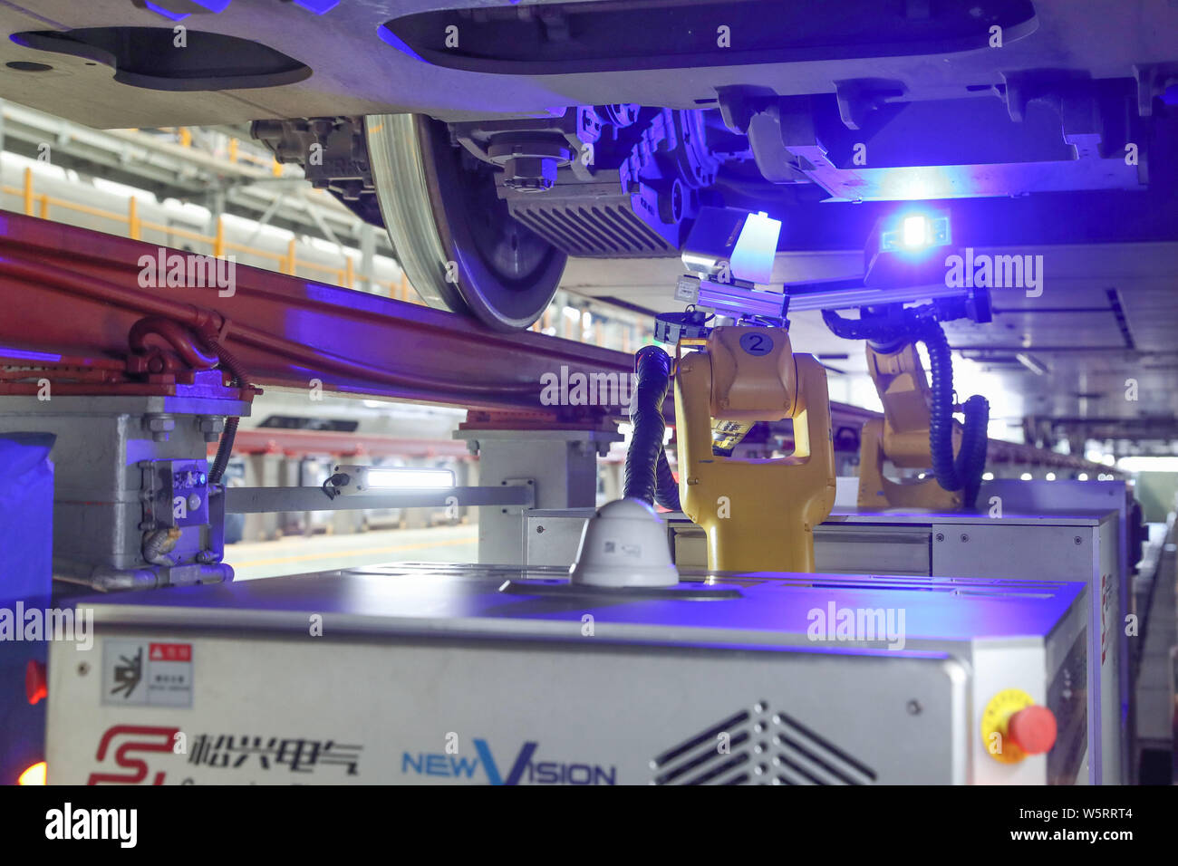 A Chinese worker operates smart robot arms to inspect and repair the ...