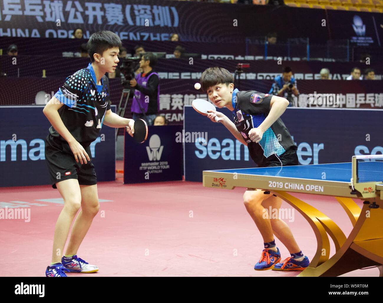 Lin Yen-jui and Cheng I-ching of Chinese Taipei return a shot to Xu Xin ...