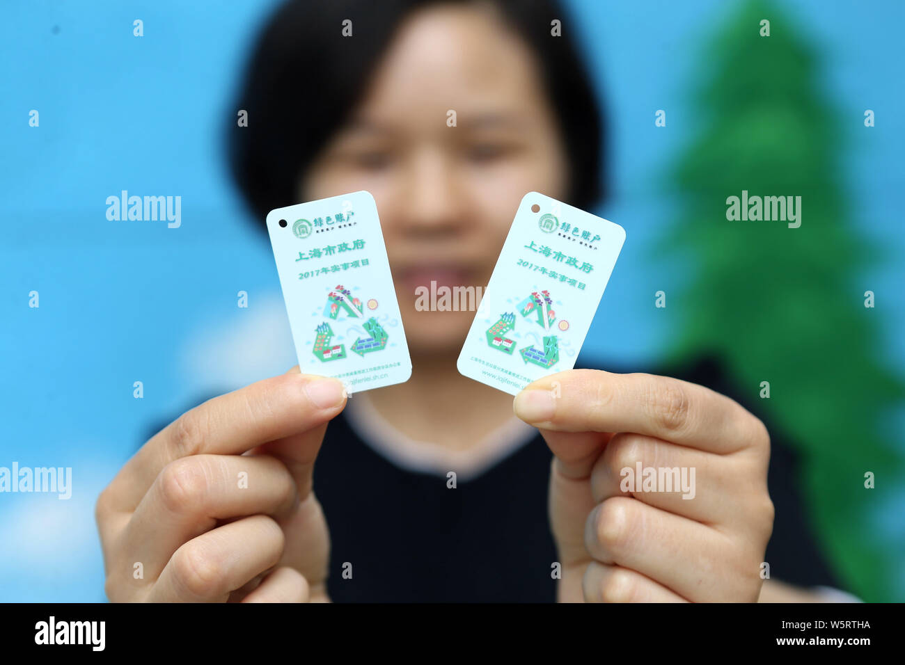Local residents shows QR code cards used to open different bins to put ...