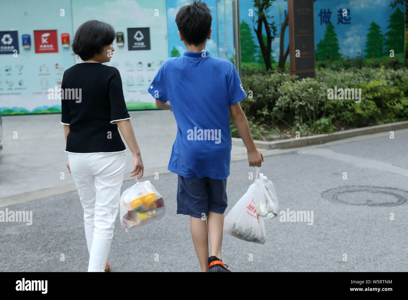 Local residents use QR code cards to open different bins to put their ...