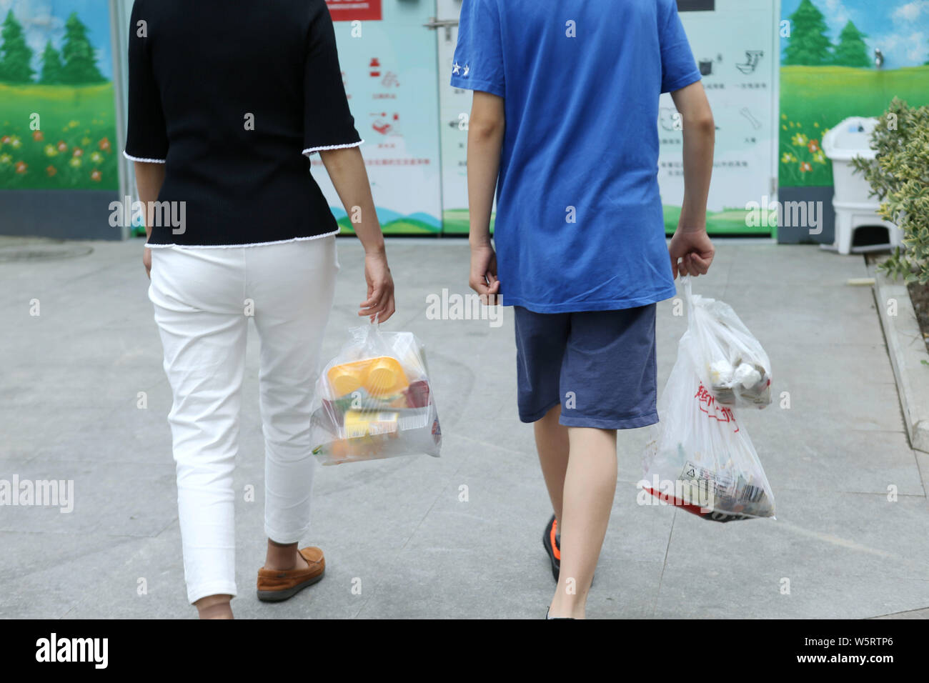 Local residents use QR code cards to open different bins to put their ...