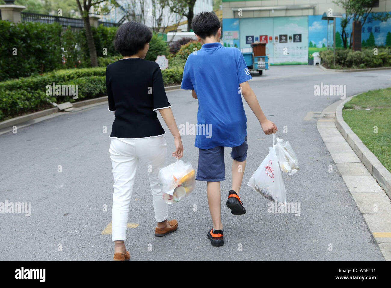 Local residents use QR code cards to open different bins to put their ...
