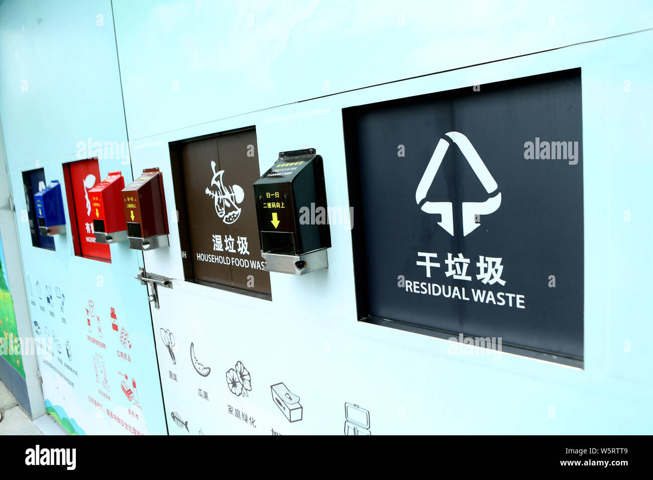 Local residents use QR code cards to open different bins to put their ...