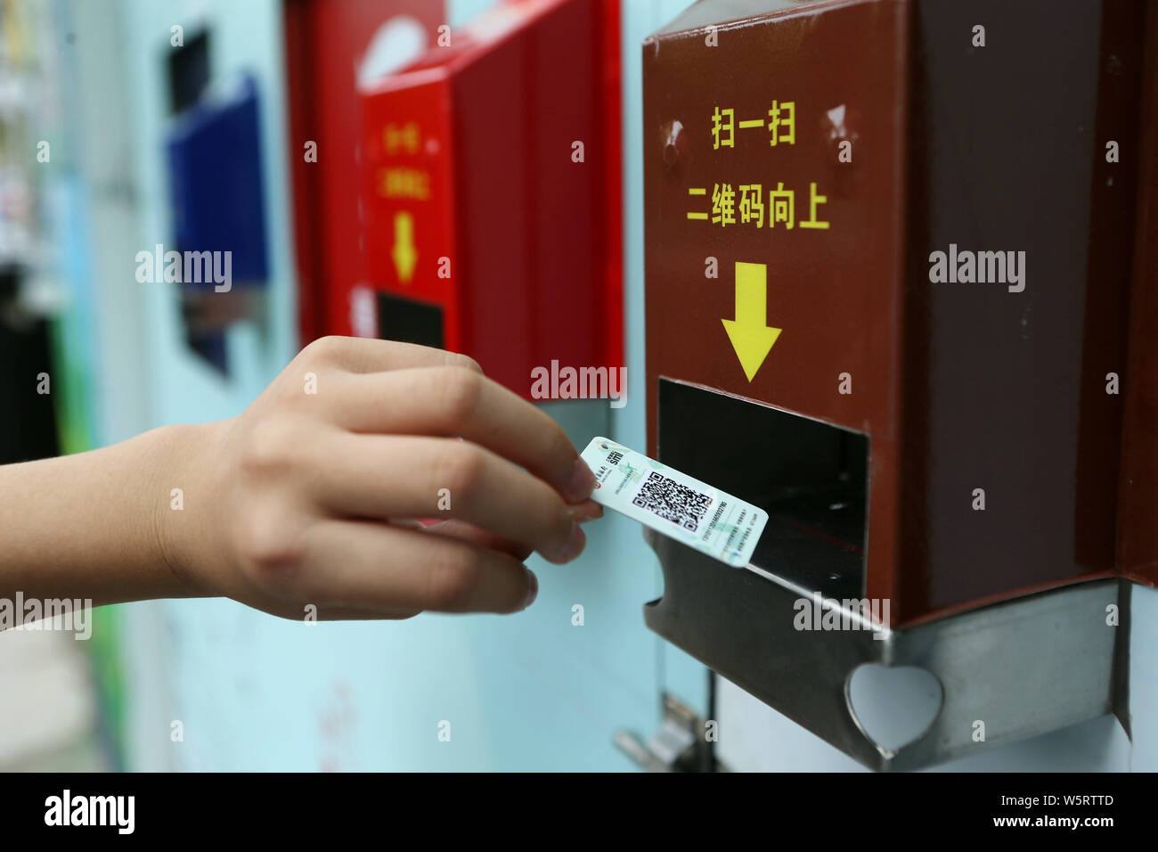 Local residents use QR code cards to open different bins to put their ...