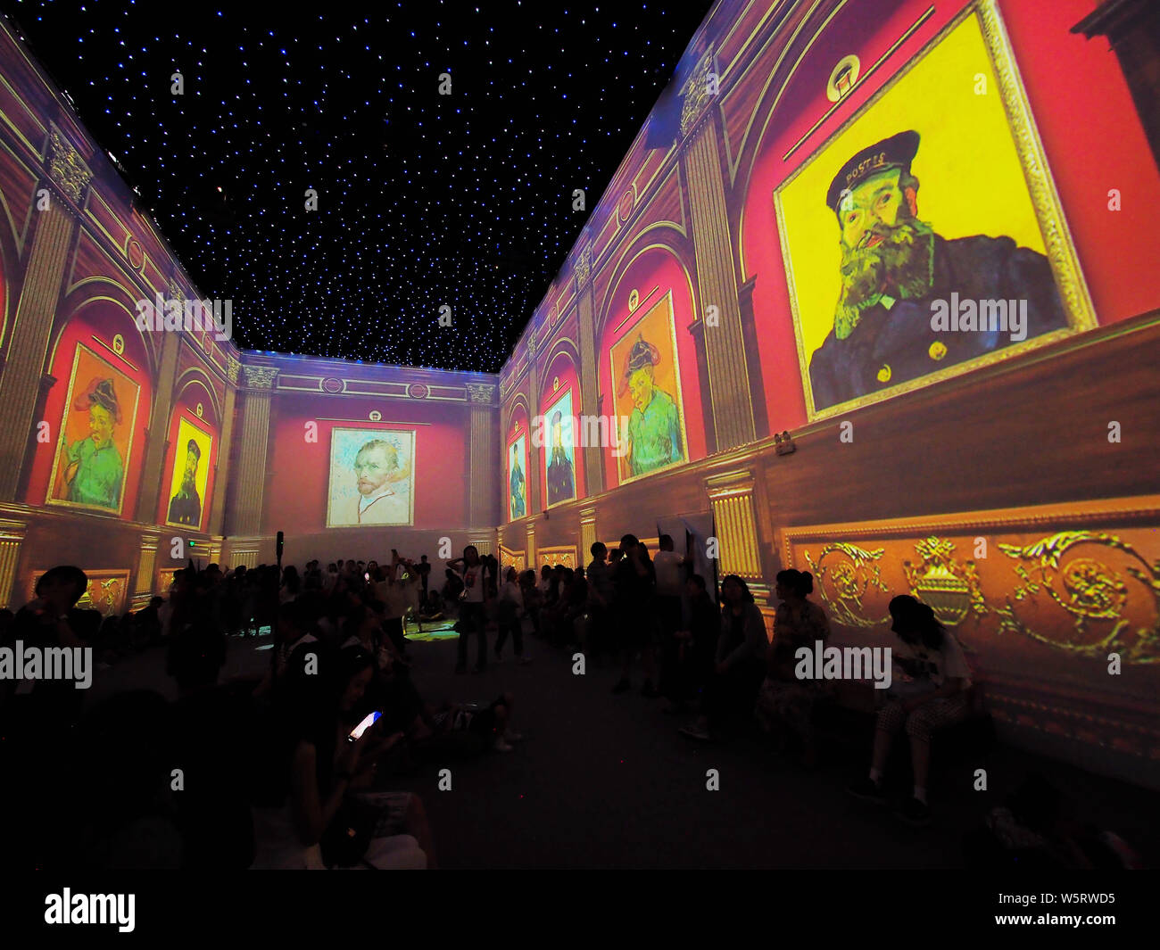 Visitors view or take pictures of a projection of art by Dutch post ...