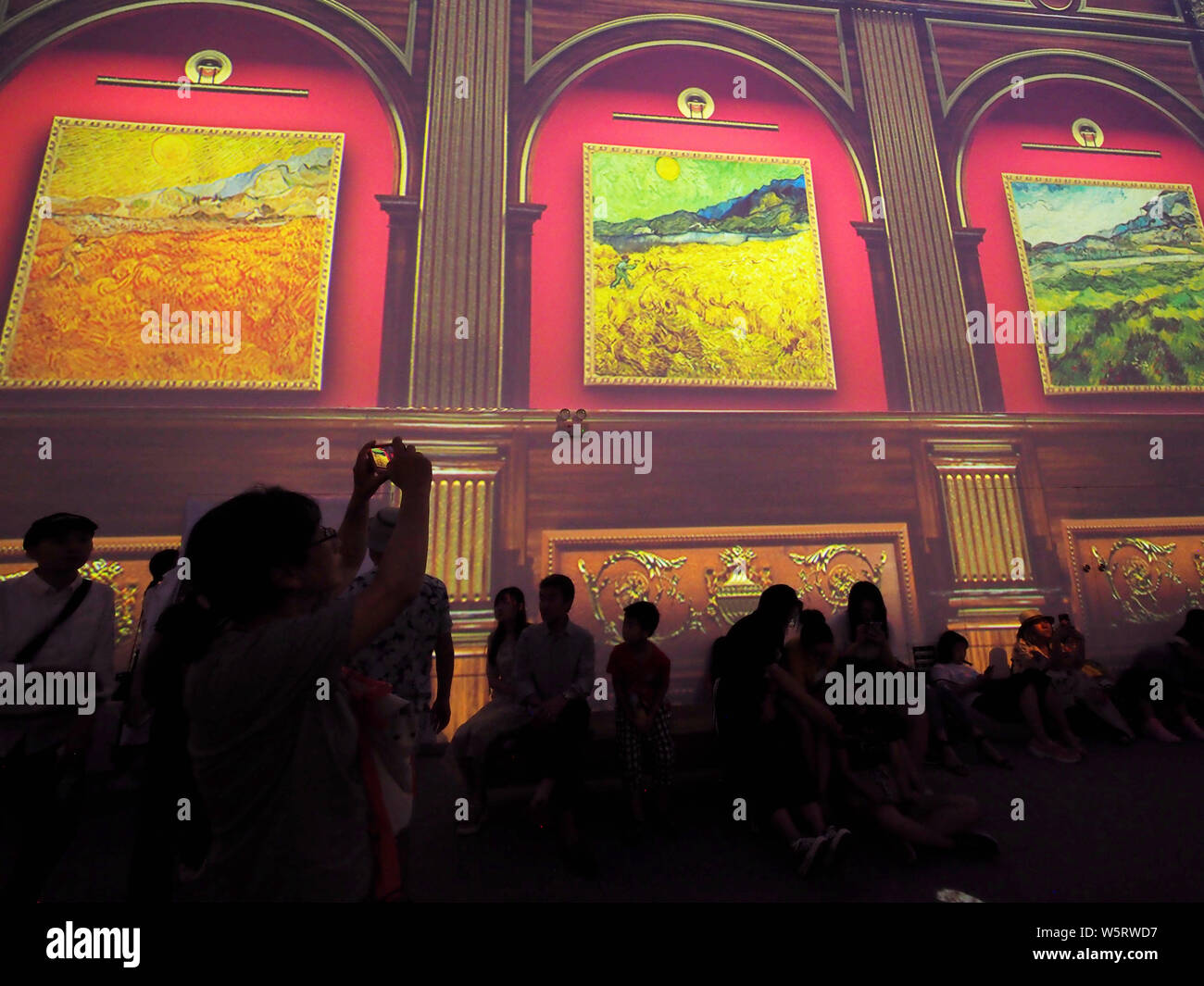 Visitors view or take pictures of a projection of art by Dutch post ...