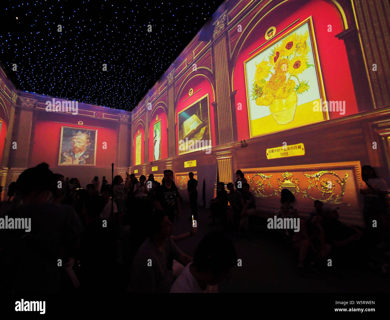 Visitors view or take pictures of a projection of art by Dutch post ...