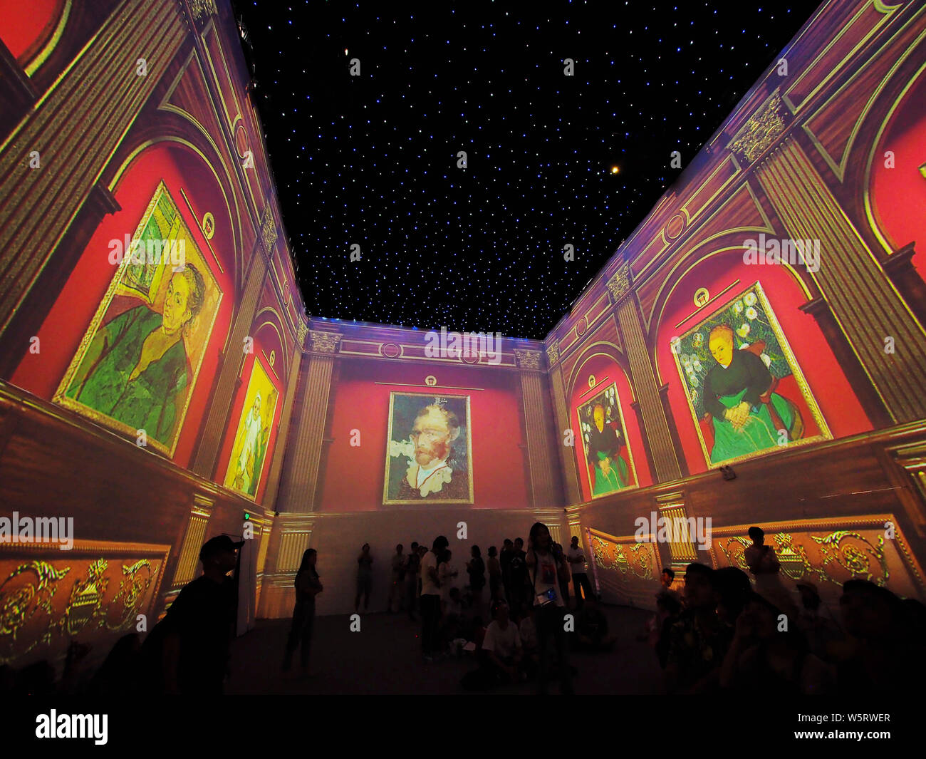 Visitors view or take pictures of a projection of art by Dutch post ...