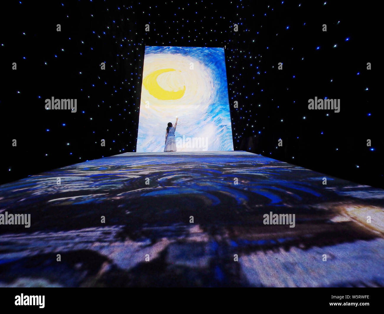 Visitors view a projection of art by Dutch post-impressionist painter ...