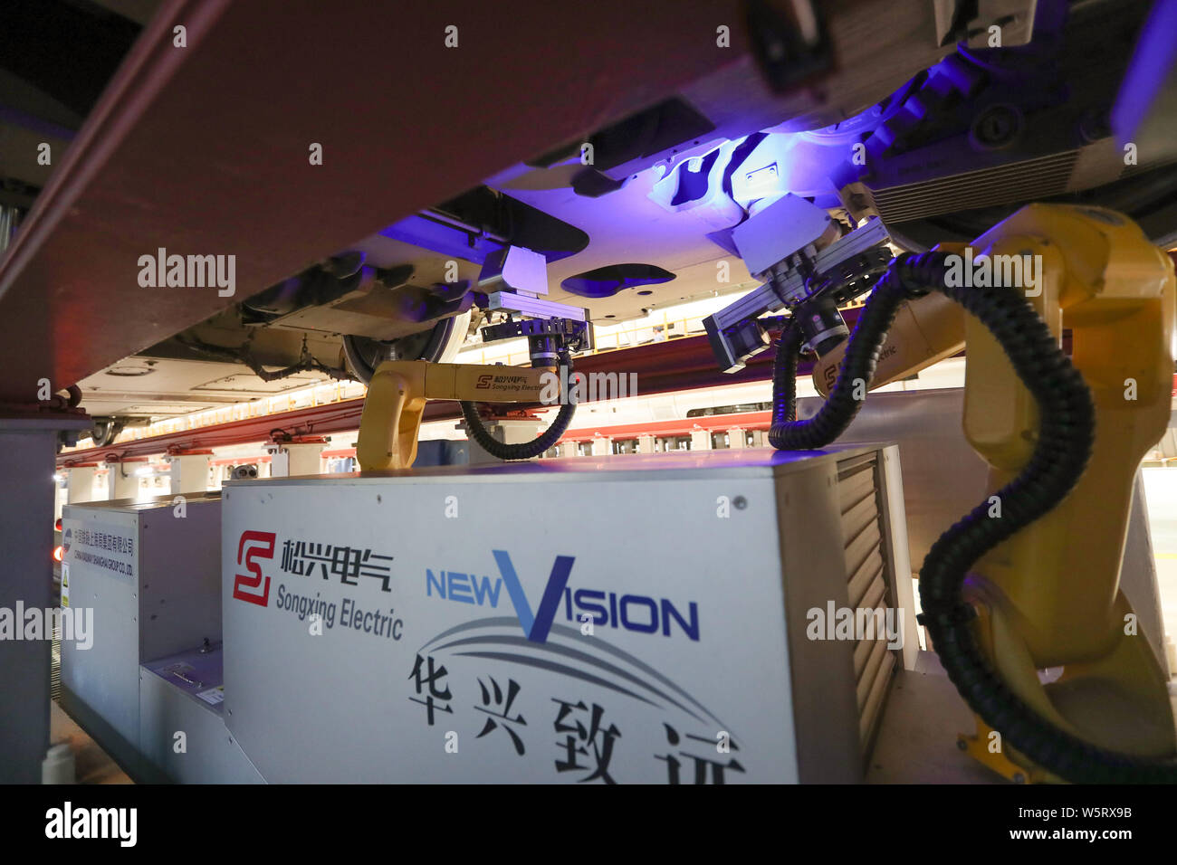 A Chinese worker operates smart robot arms to inspect and repair the ...