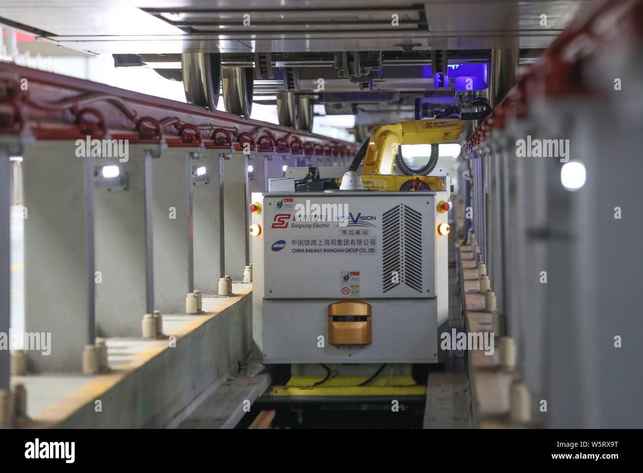 A Chinese worker operates smart robot arms to inspect and repair the ...