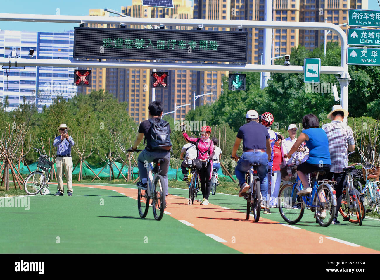 Local residents ride bikes on the first bicycle-only road, which is ...