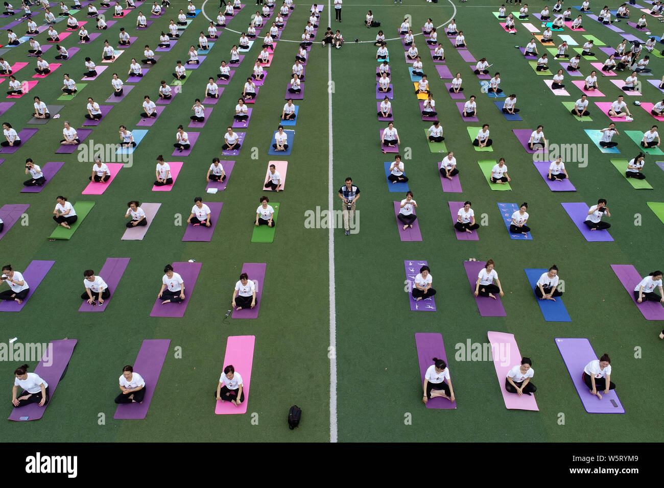 Thousands of Chinese yoga lovers practice yoga to mark the upcoming ...