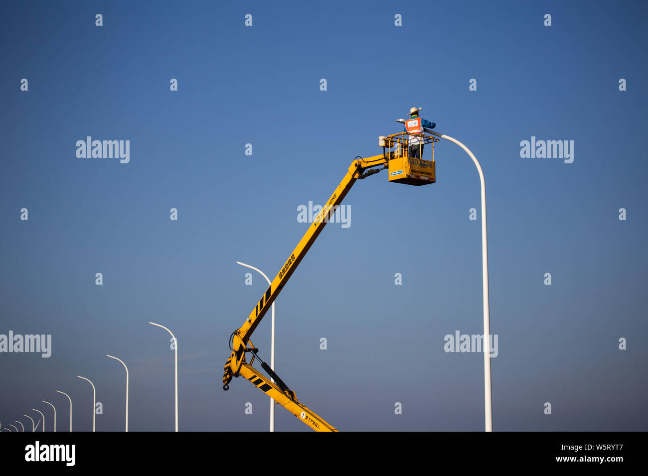 Chinese workers labor at the construction site of the Poyang Lake No. 2 ...