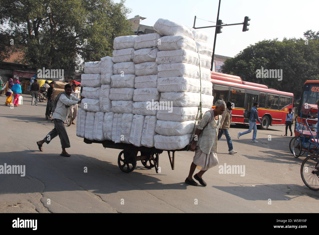 Man pulling an overloaded cart Stock Photo - Alamy
