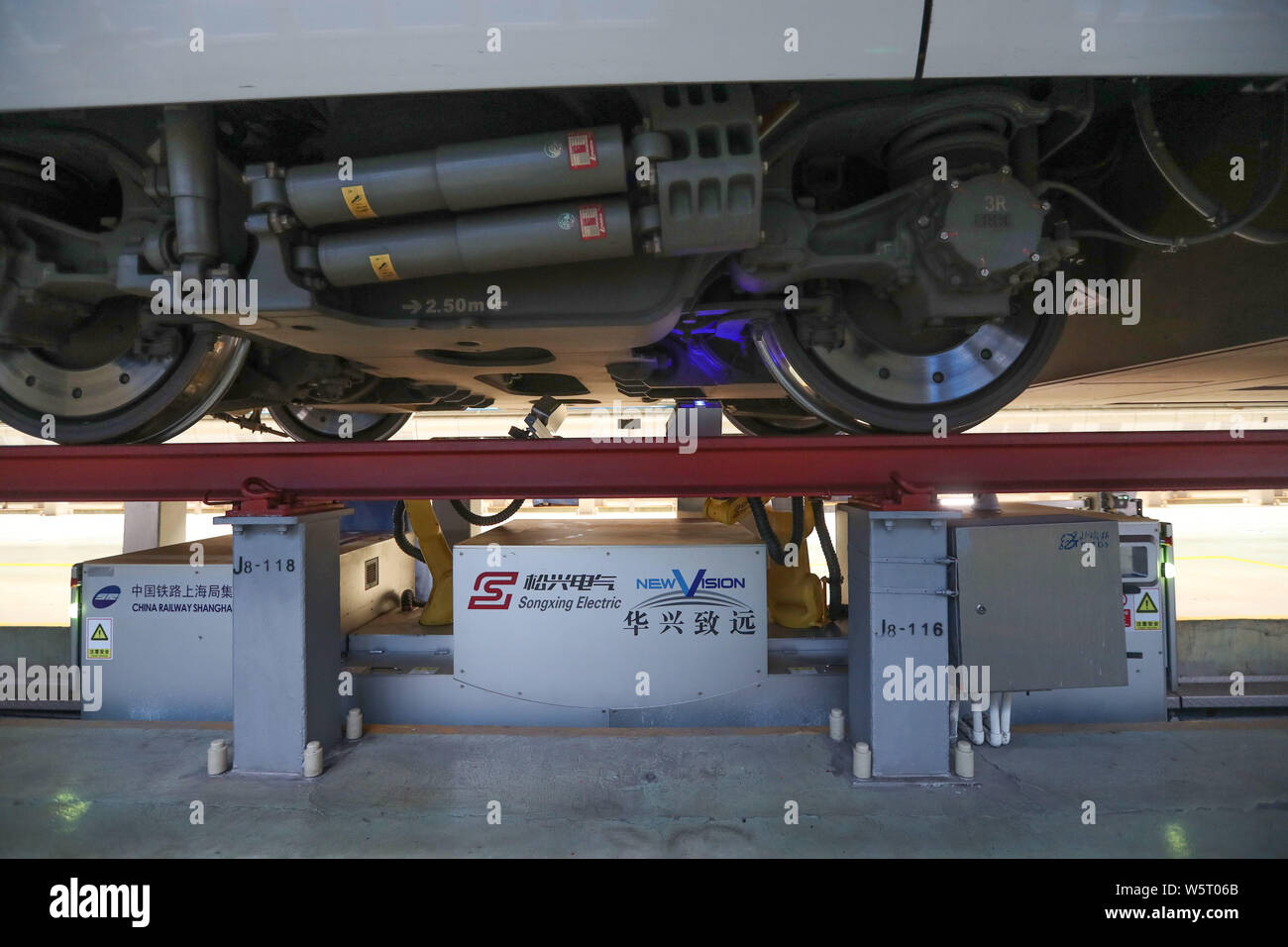 A Chinese worker operates smart robot arms to inspect and repair the ...