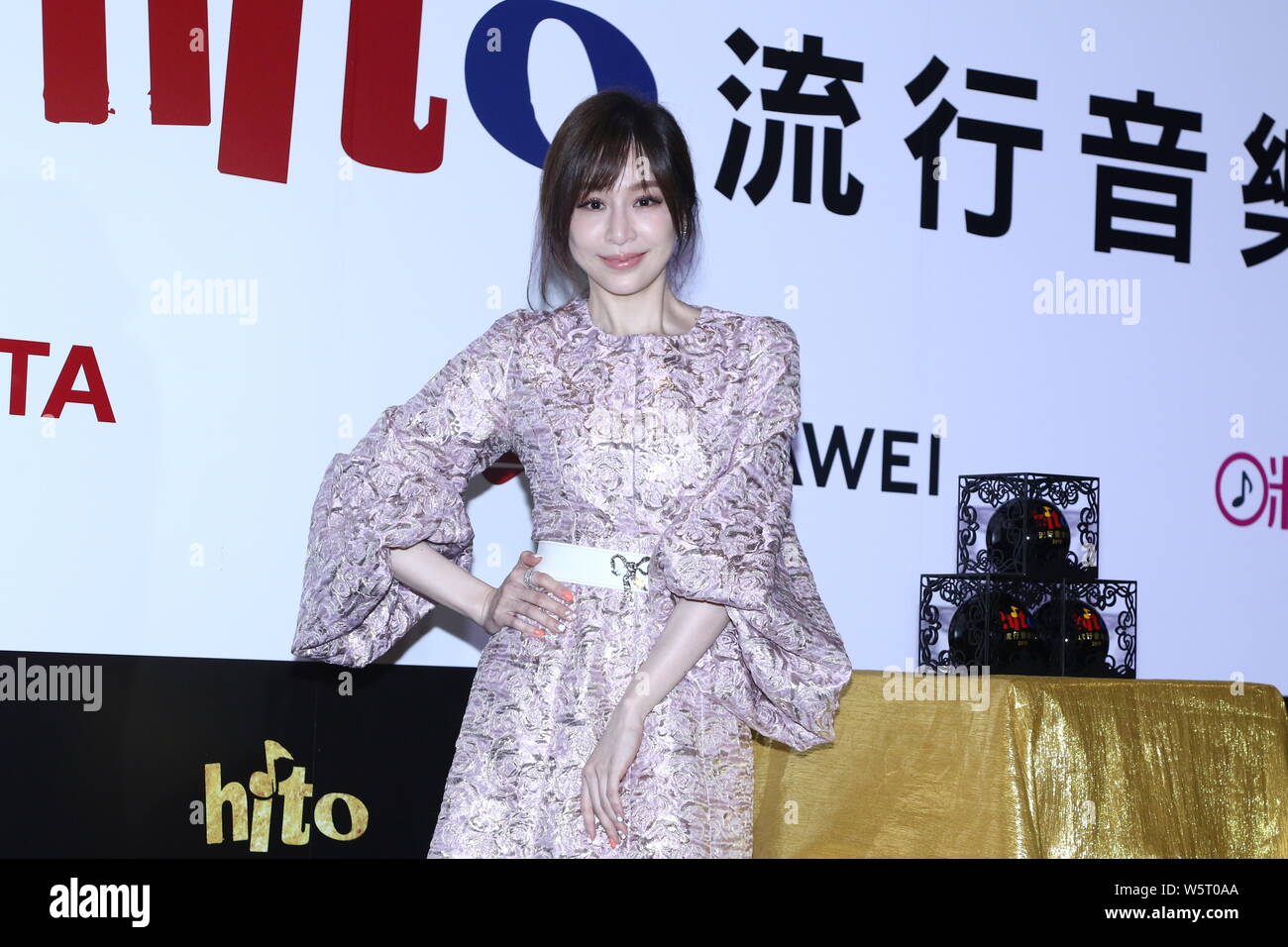 Taiwanese singer and actress Cyndi Wang poses with her trophies during ...