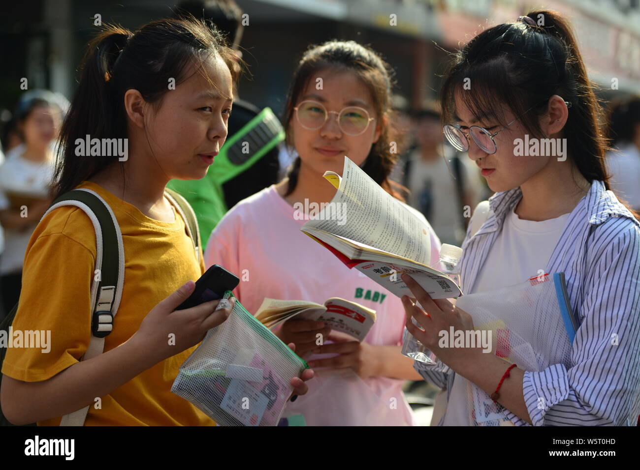 Young Chinese student examinees make final reviews of textbooks before ...