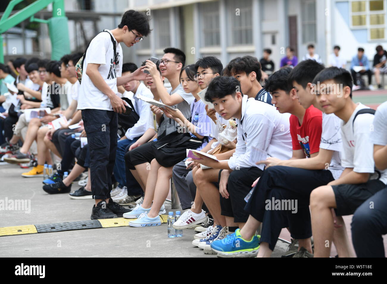 Young Chinese student examinees make final reviews of textbooks before ...