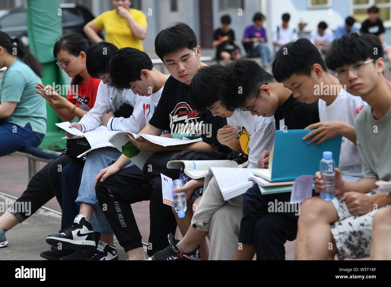 Young Chinese student examinees make final reviews of textbooks before ...