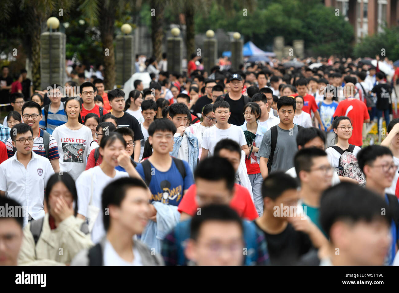 A crowd of young Chinese student examinees walk out from a middle ...